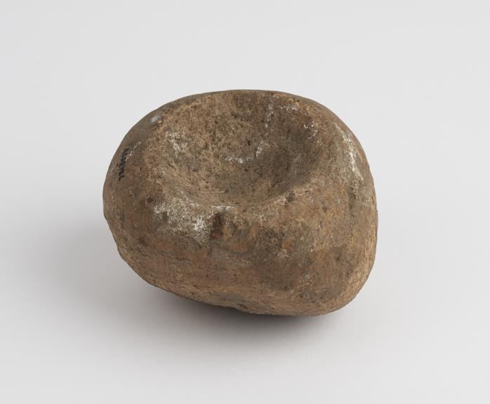 Mortar, ovoid stone with circular depression on upper surface | Science ...