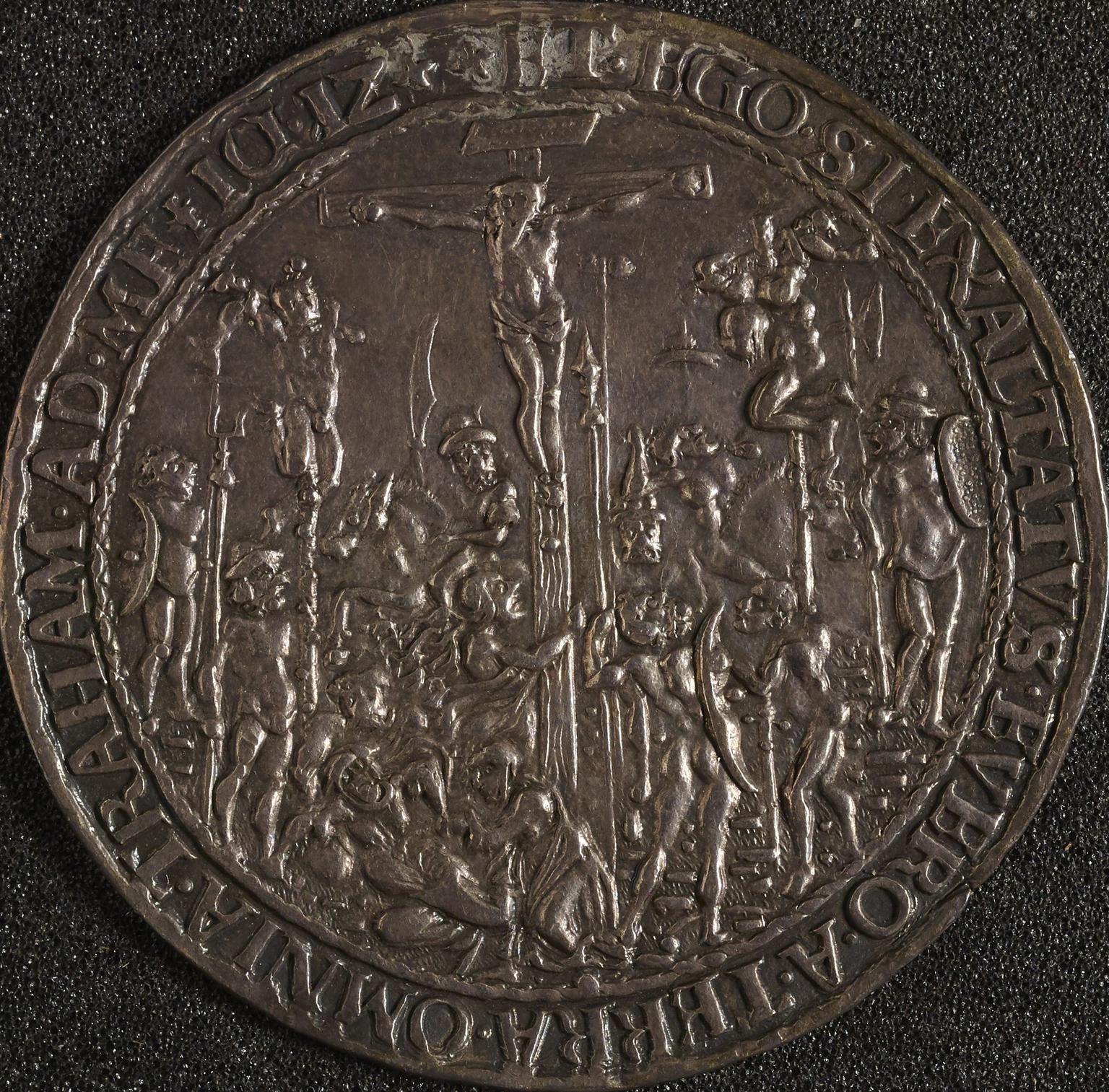 Circular silver amuletic medal with scene of crucifixion on obverse and ...